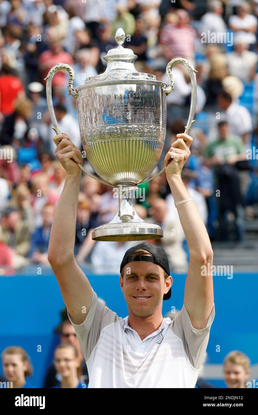 Sam Querrey of U.S. holds up the winner's trophy after defeating Mardy ...