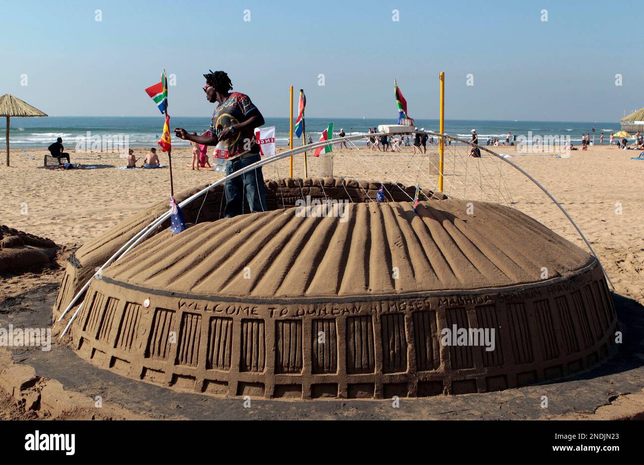 A man builds a sand castle replica of the Durban Stadium were Australia ...