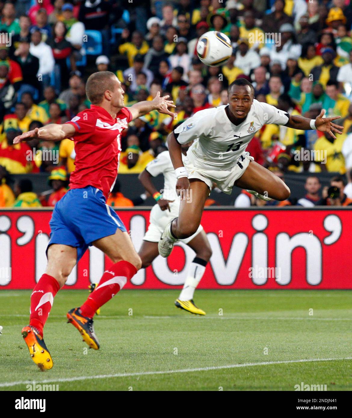 Serbia's Nemanja Vidic, left, and Ghana's Dede Ayew, right, go for the ...