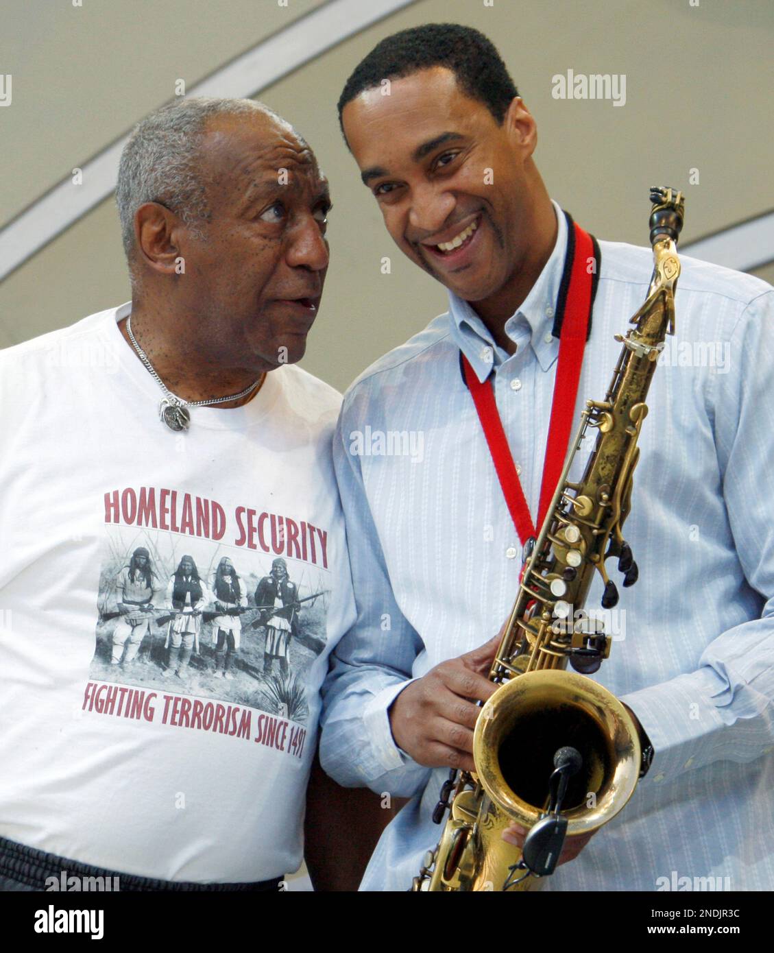 Emcee Bill Cosby, left, shares a moment with bandleader Javon Jackson ...