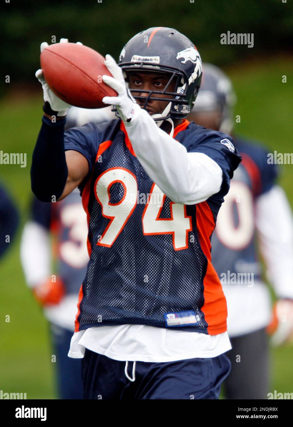 Denver Broncos linebacker Jarvis Moss catches a pass during drills in ...