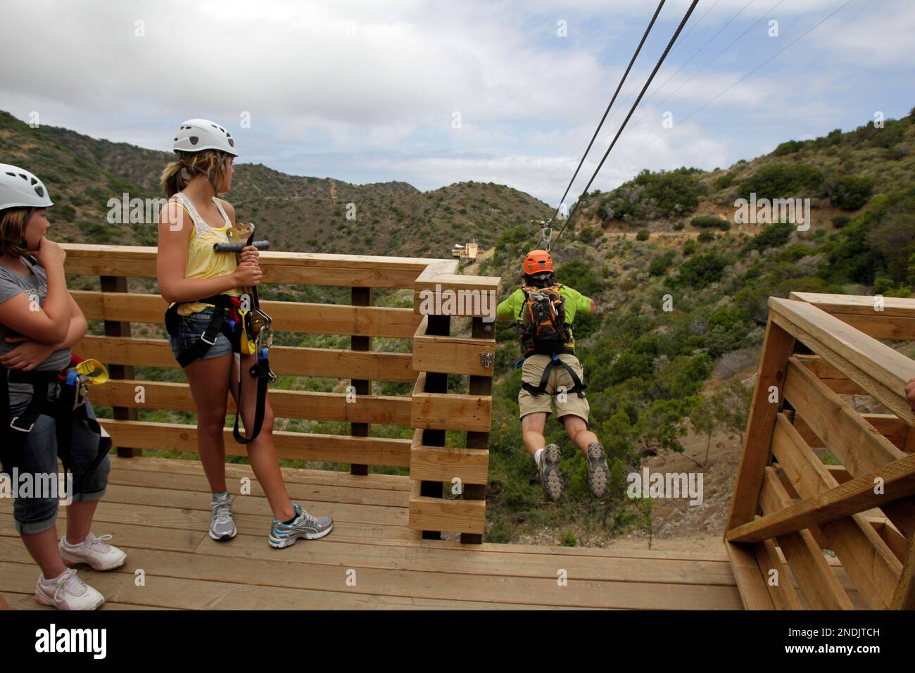 In this June, 9, 2010 photo, Zip line guide Charles Oddone, right ...