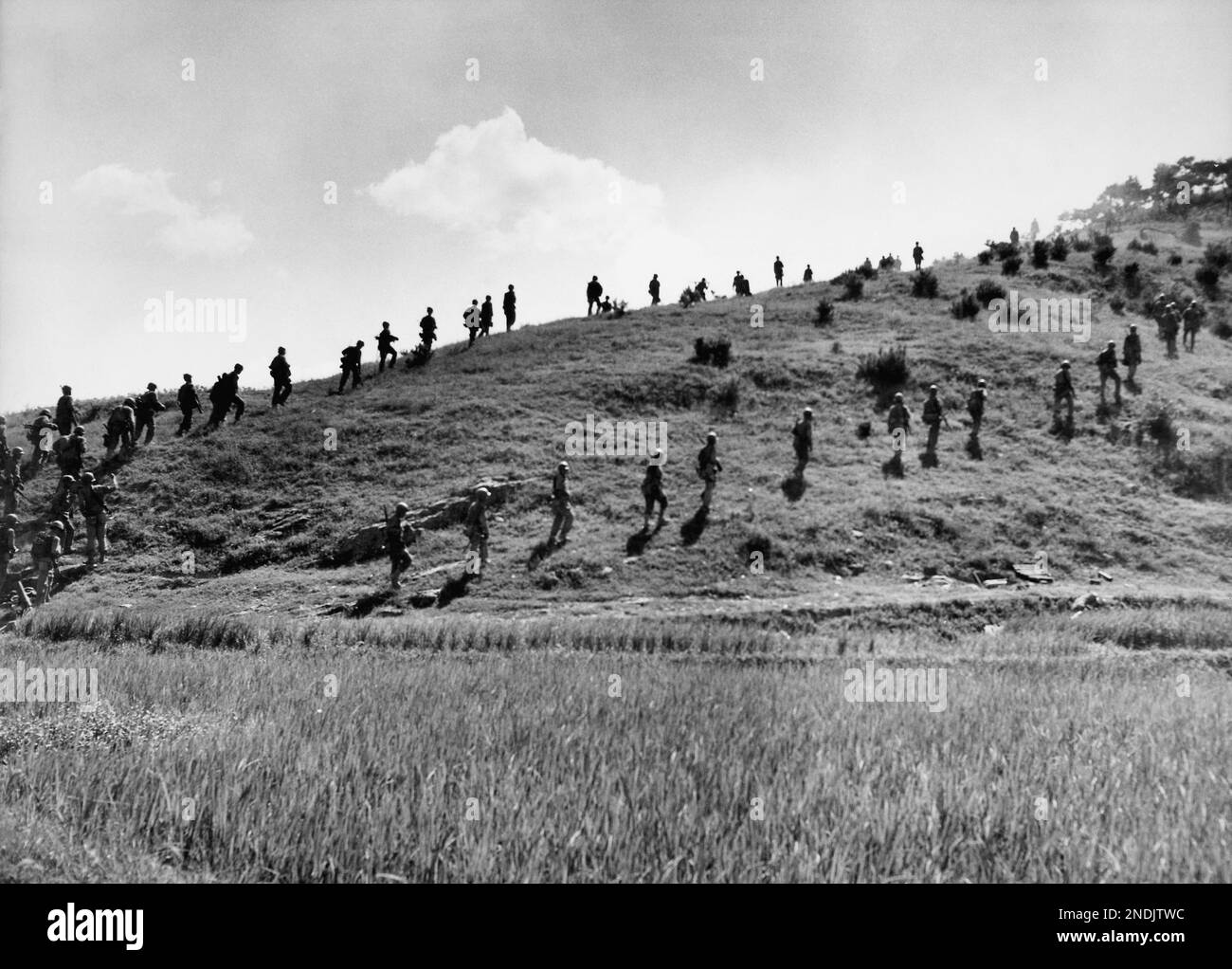 FILE - In this August 1950 file photo, U.S. Marines advance up a ridge ...