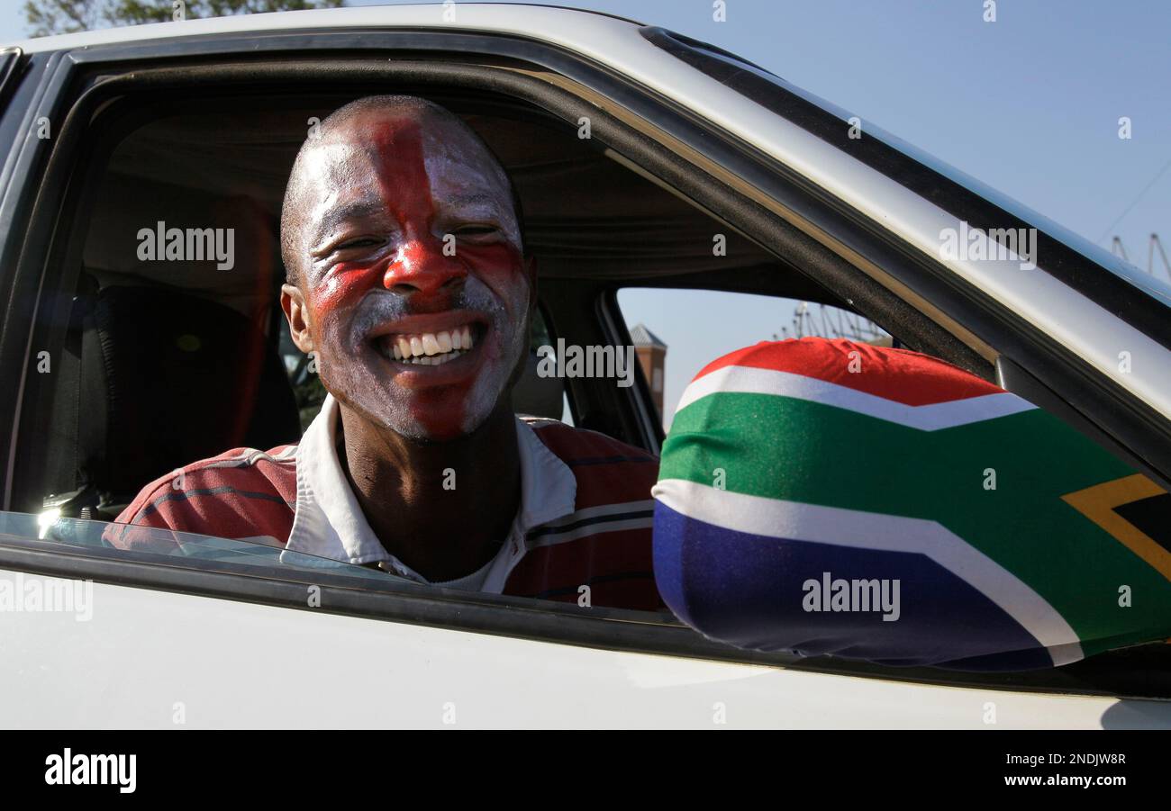 A South African soccer fan with the England flag painted on his face ...