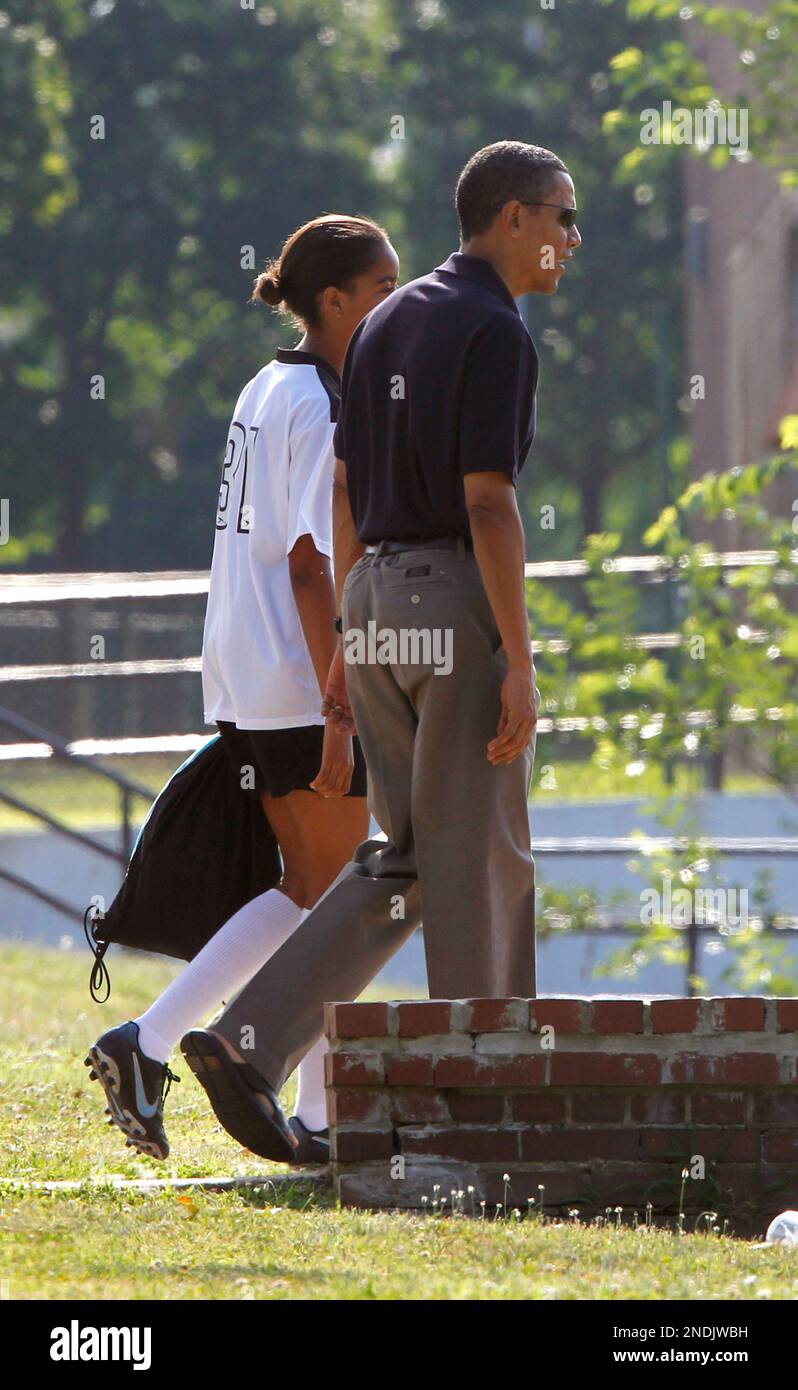 President Barack Obama, right, and his daughter Malia, left, arrive at ...