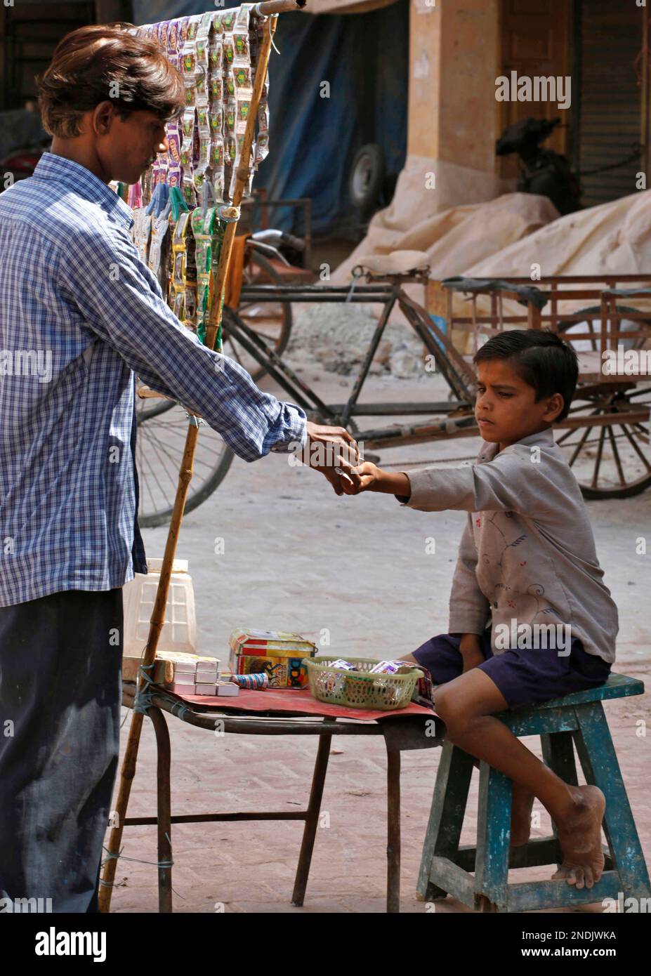 A young wayside vendor sells tobacco on World Day Against Child Labor ...