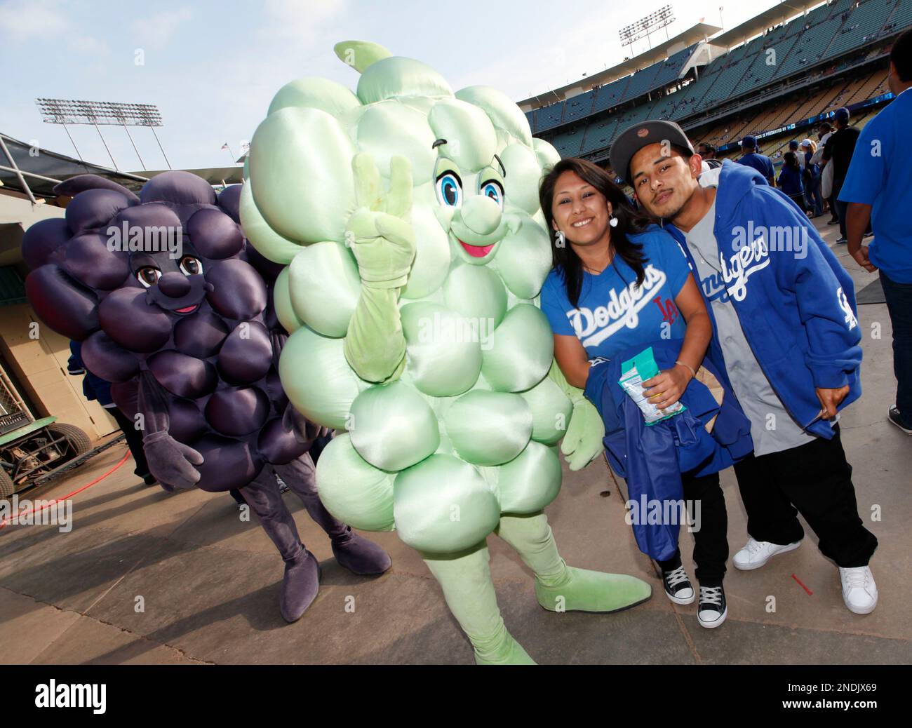 Guests pose blue-black and green grapes during Grapes From California ...