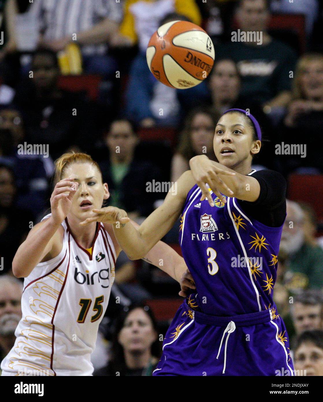 Los Angeles Sparks' Candace Parker, right, passes as Seattle Storms ...