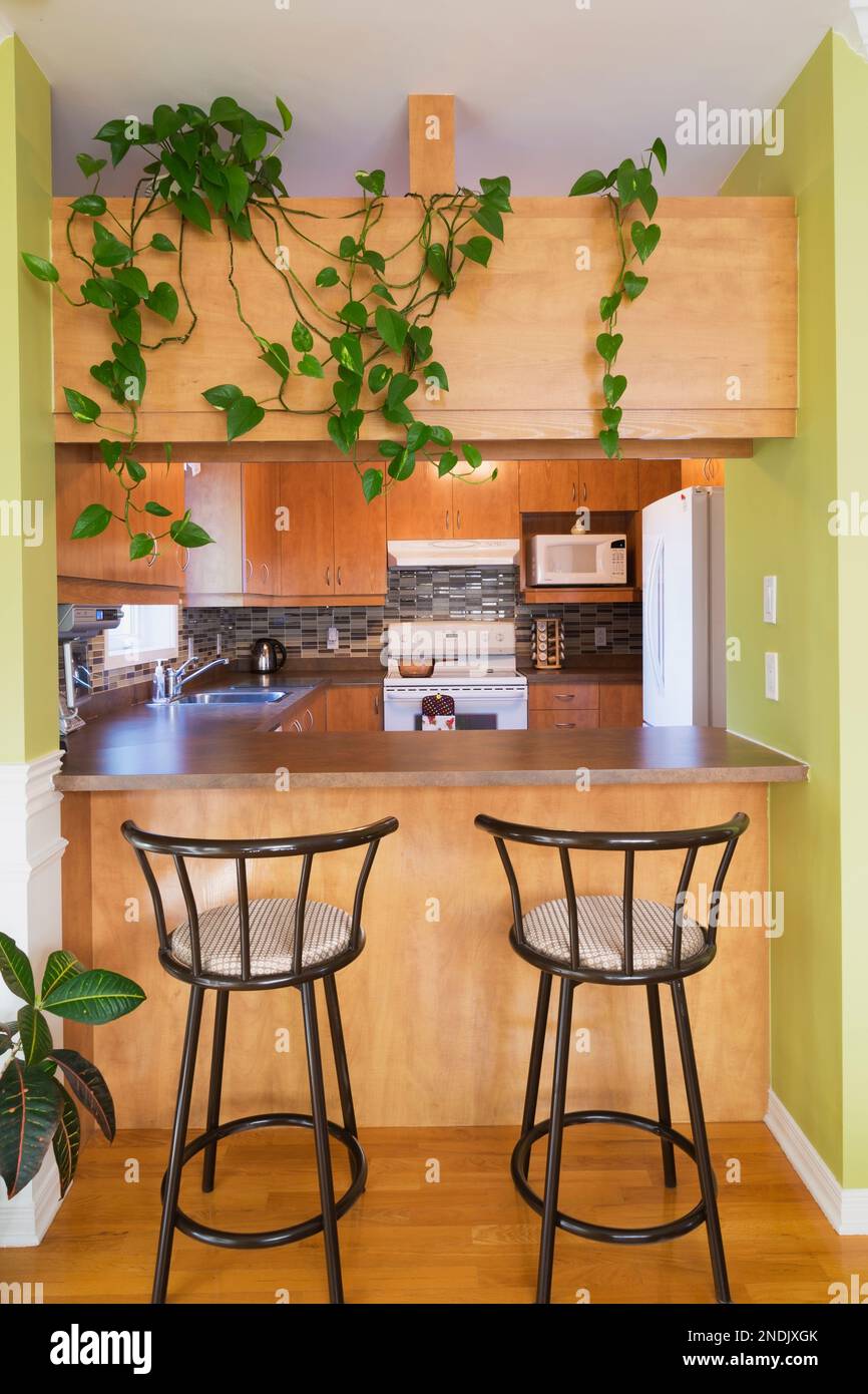 Kitchen counter with bar stools inside country style house Stock Photo ...