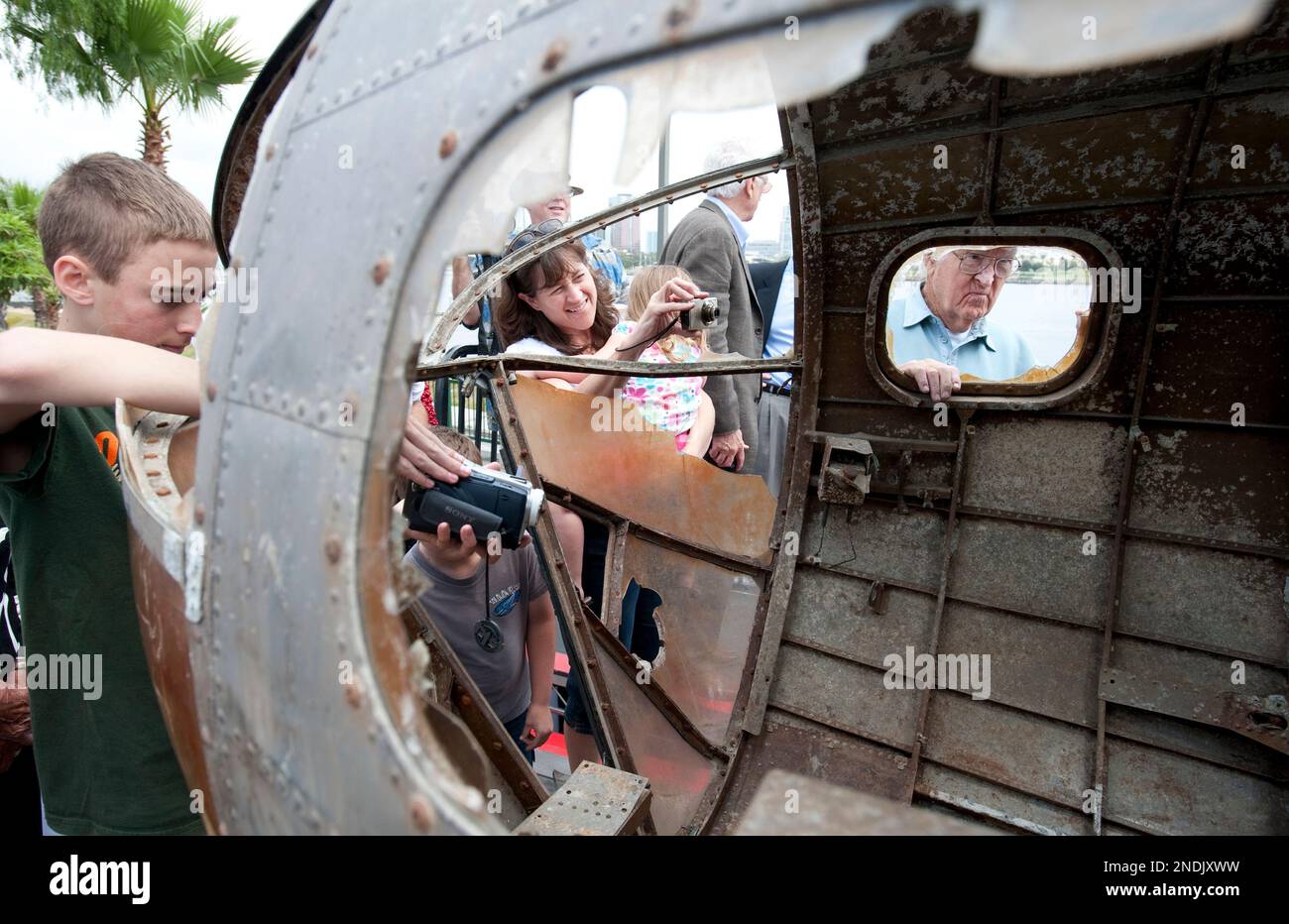 Visitors young and old examine the cockpit of the Swamp Ghost, a B-17E ...