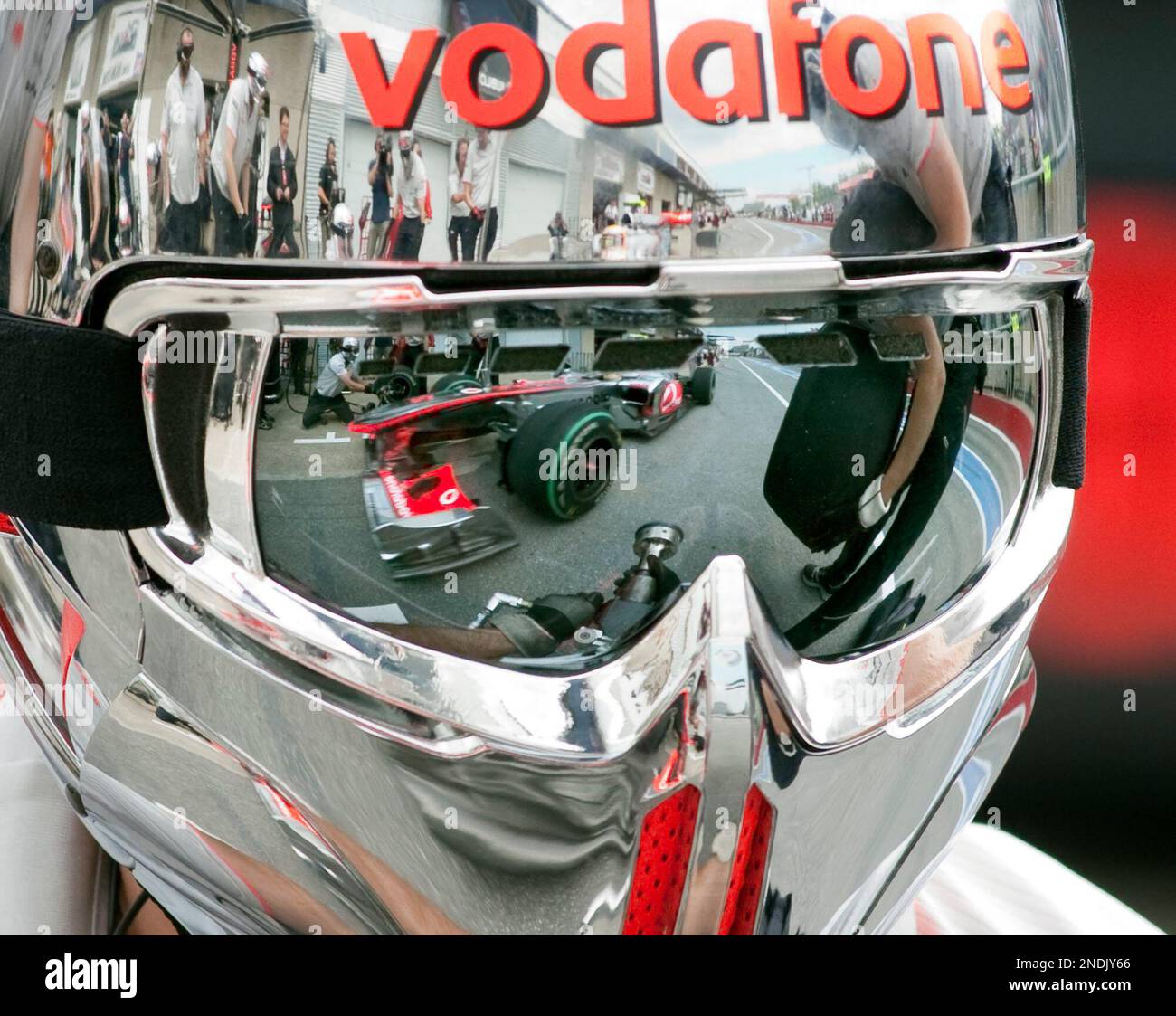 McLaren Mercedes driver Lewis Hamilton of Britain is reflected in the ...