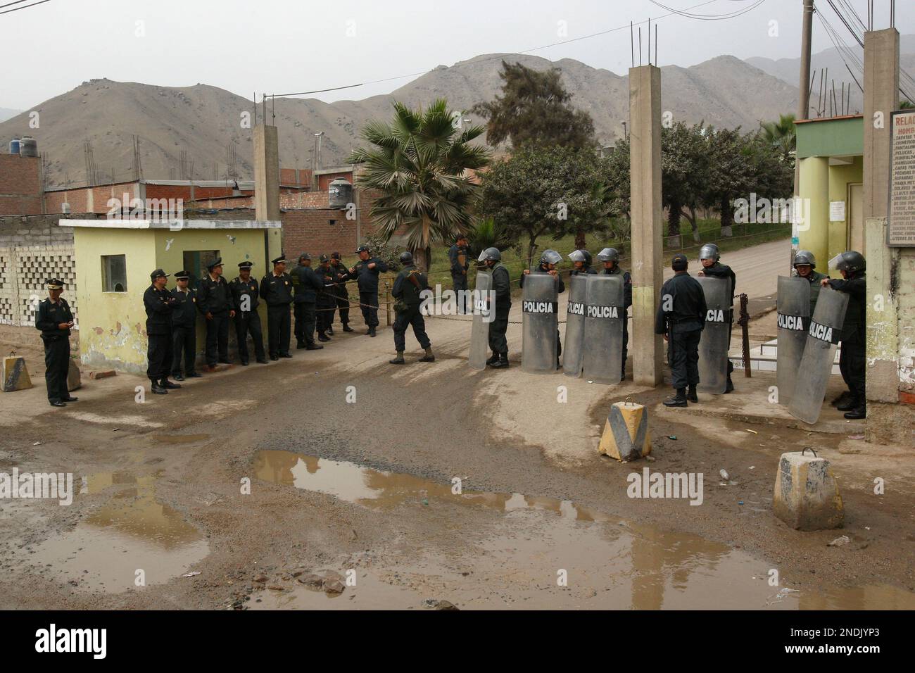 Peru's police officers stand on guard outside the entrance of Miguel ...