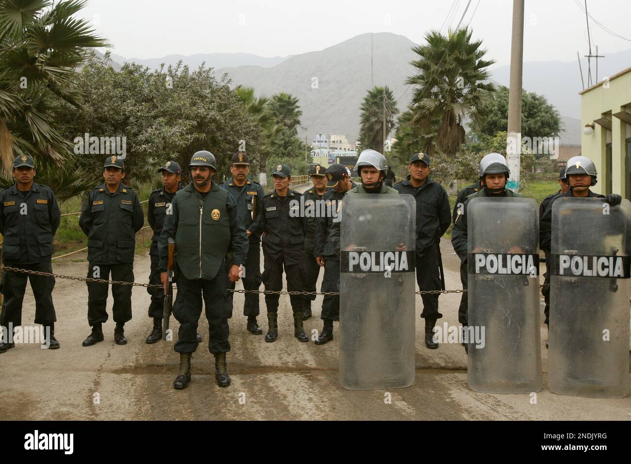 Police officers stand guard outside the Miguel Castro Castro prison ...