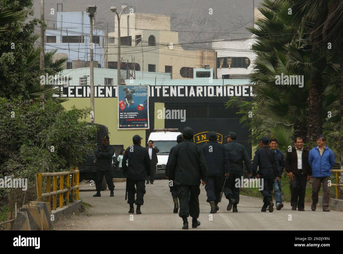 Police officers walk outside the Miguel Castro Castro prison where ...