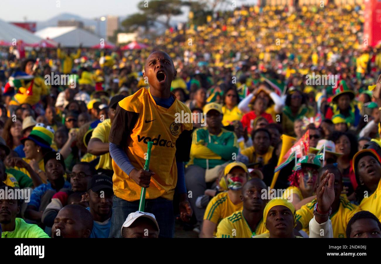 South African soccer fans react as they watch in a giant screen the ...