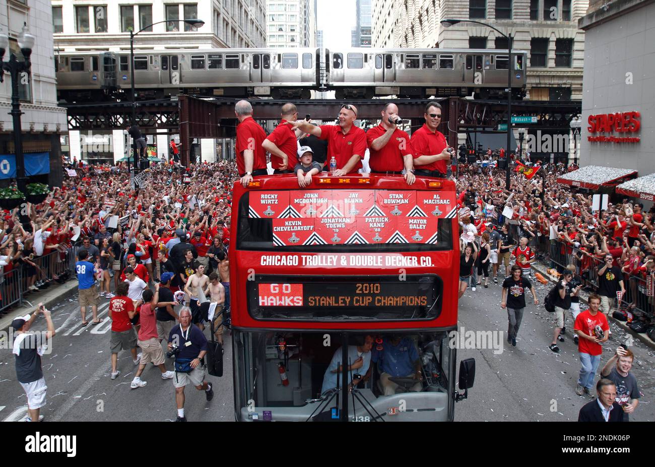Chicago Blackhawks players and staff members celebrate in a bus during ...