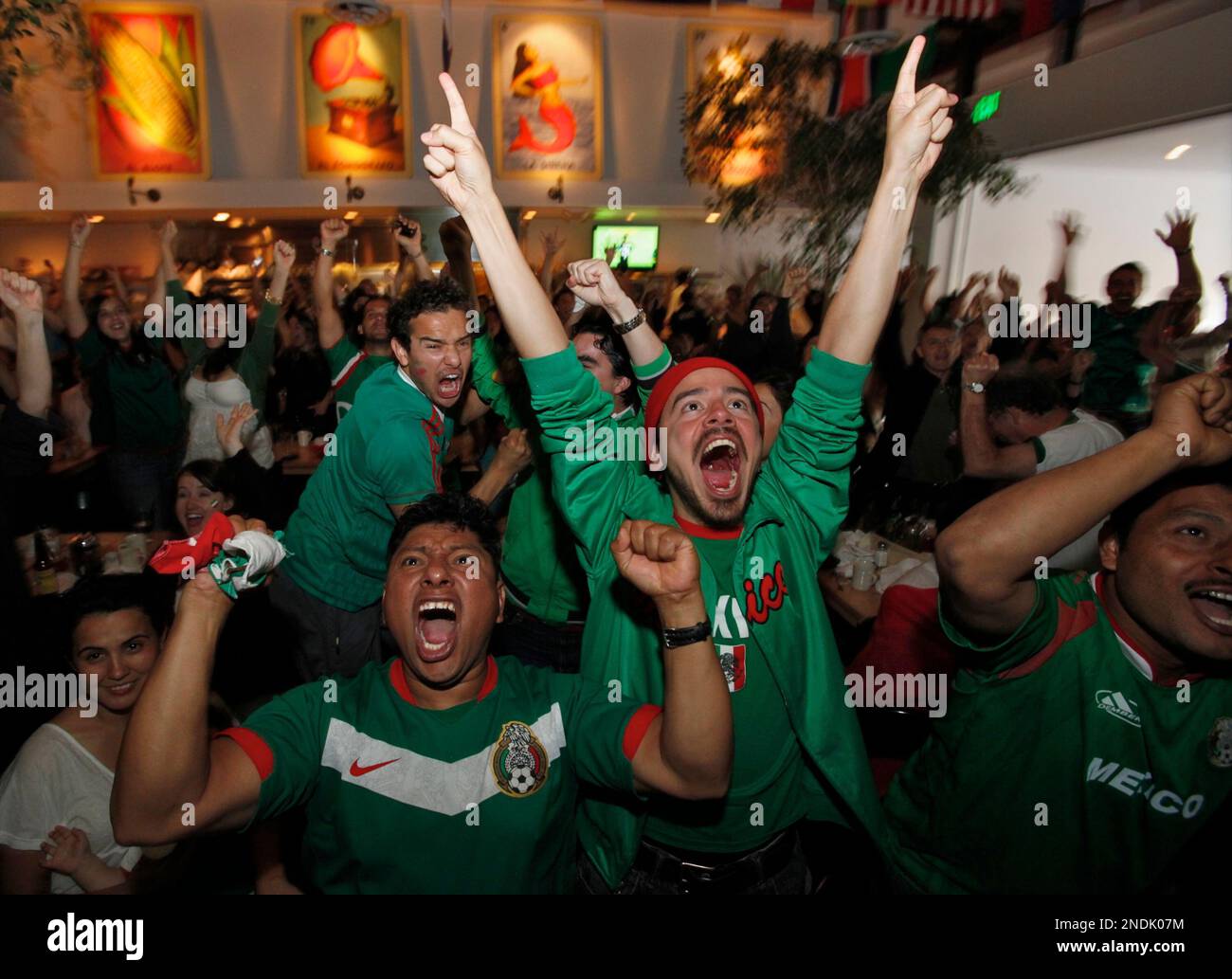 Mexican fans celebrate Mexico's goal during the opening game between ...