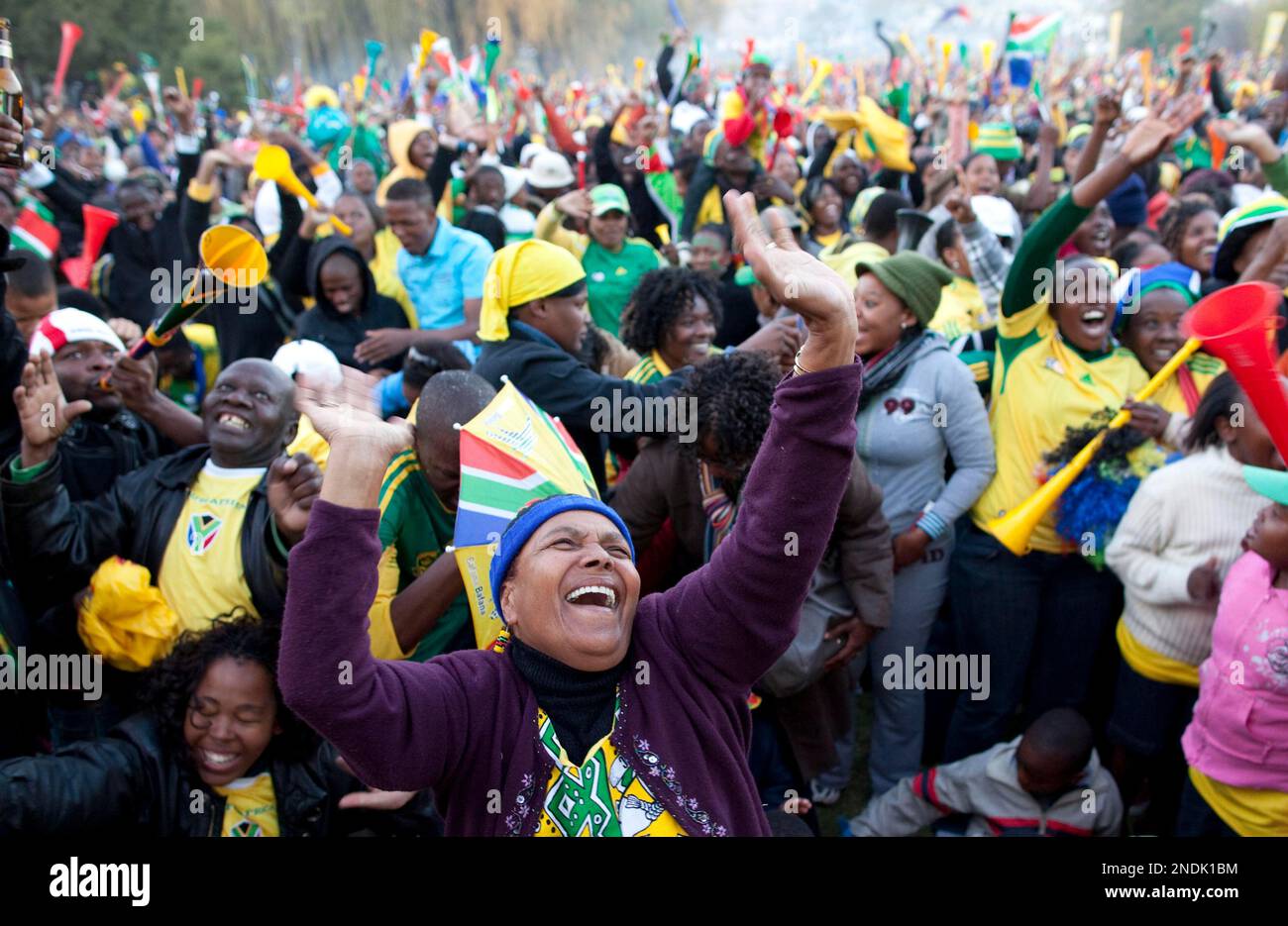 South African soccer fans celebrate scoring the opening goal as they ...