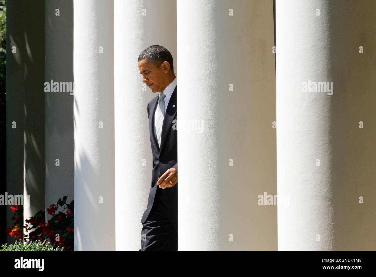 President Barack Obama walks through the columns of the West Wing ...