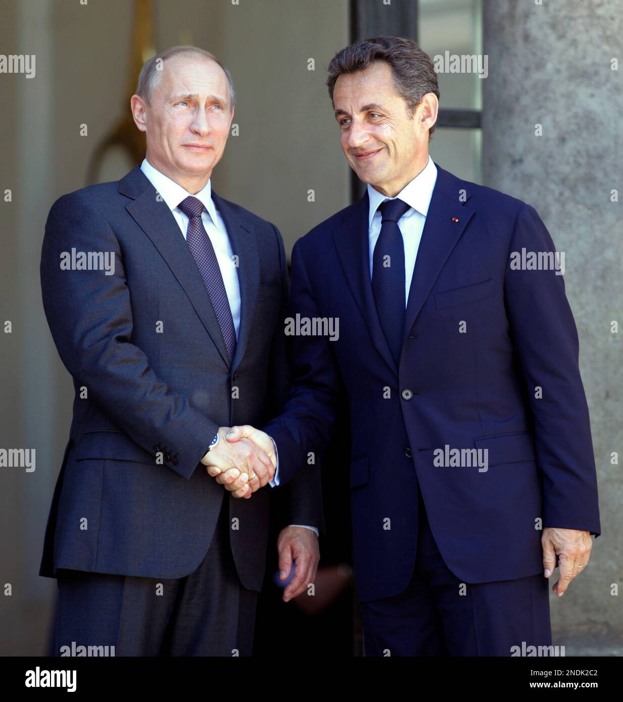 French President Nicolas Sarkozy, right, welcomes Russian prime ...