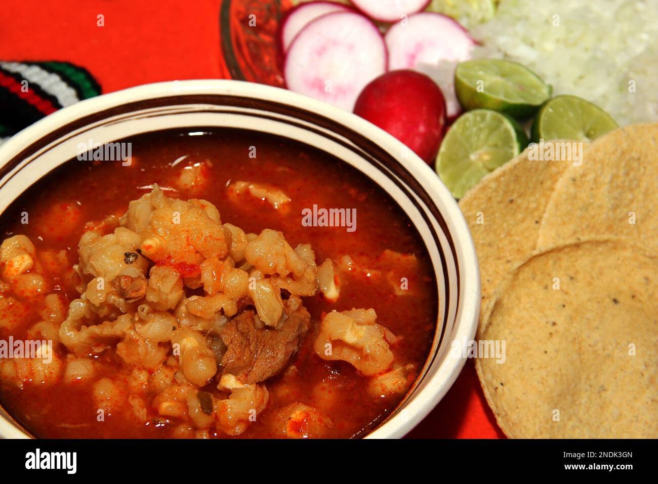 Typical Mexican food, plate of pozole with corn, meat, vegetables and ...