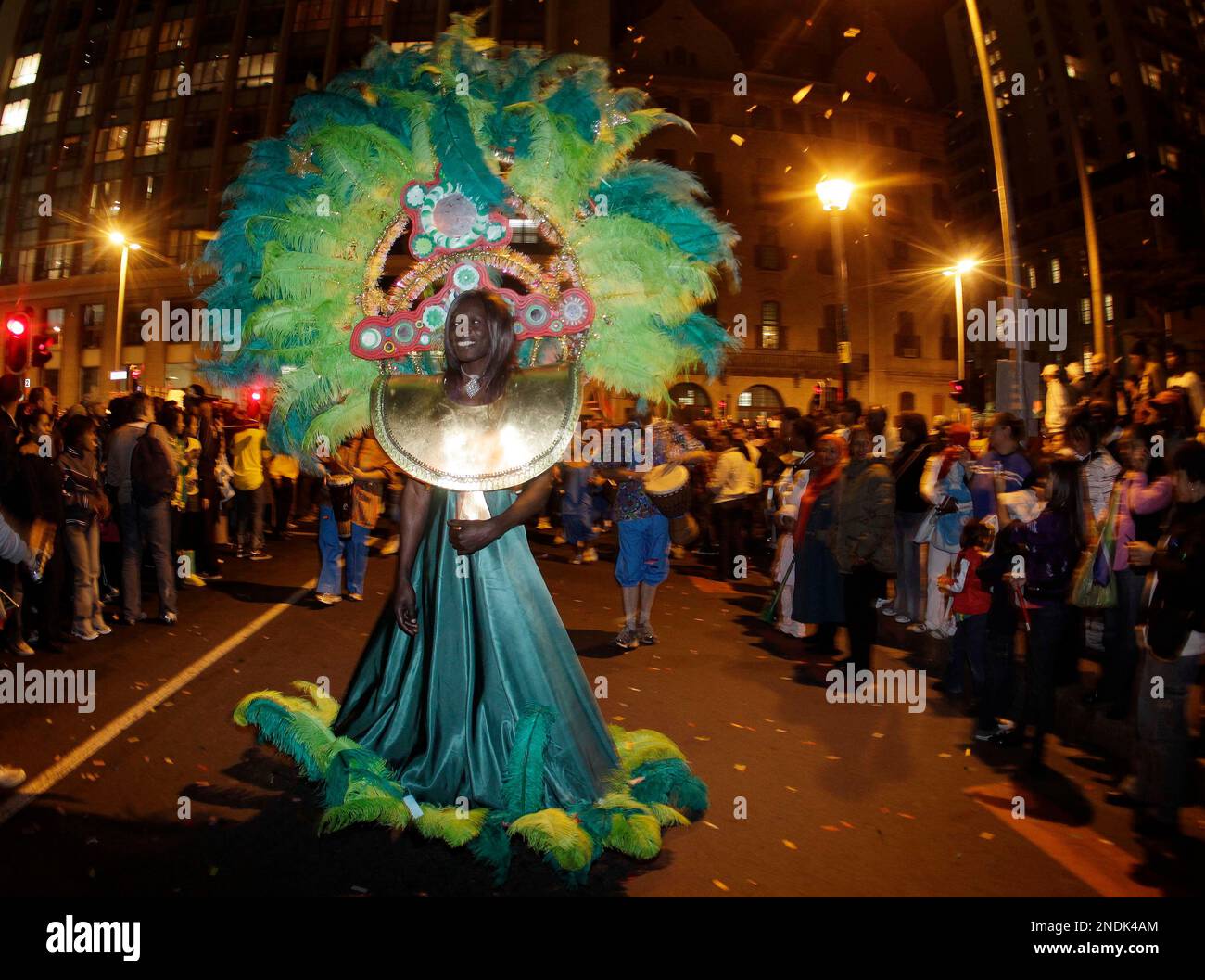 A drag queen walks through the city center streets during a Fan Fest ...