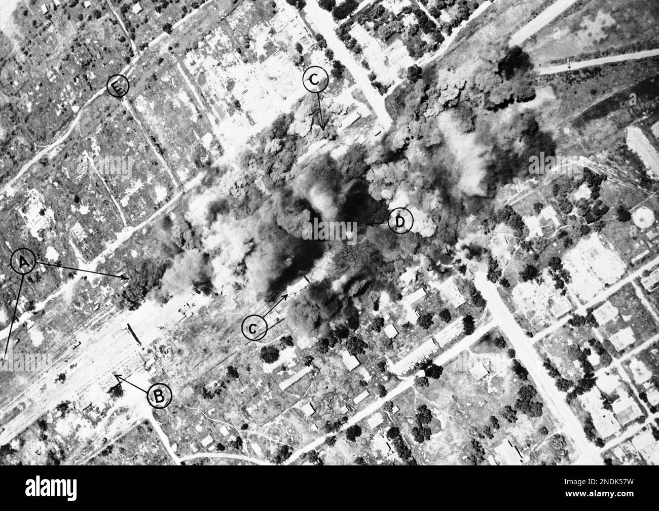 Dense smoke rises from heavy bombardment by U.S. Army Air Forces planes ...