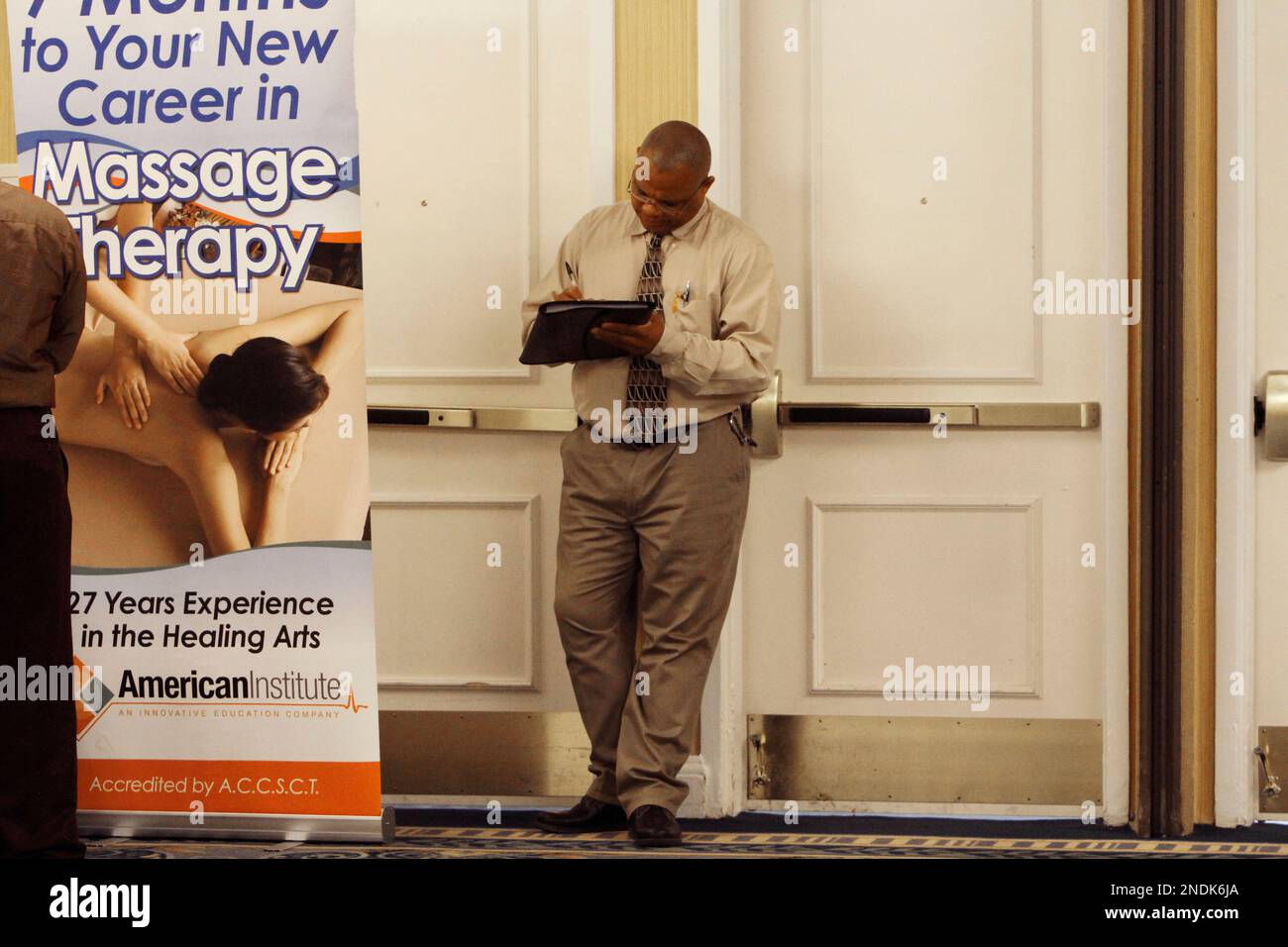 Harold Thompson fills out an application at the National Career Fair in ...