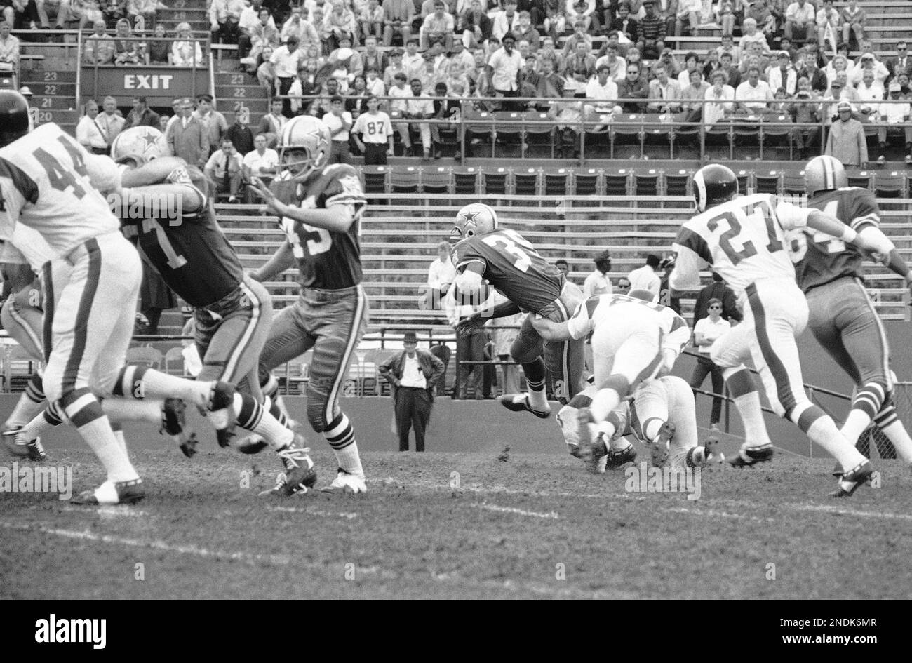 Calvin Hill (35) Dallas Cowboys running back is up and almost away from ...