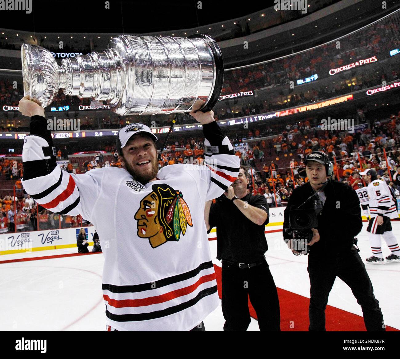 Chicago Blackhawks defenseman Jordan Hendry lifts the Stanley Cup after ...