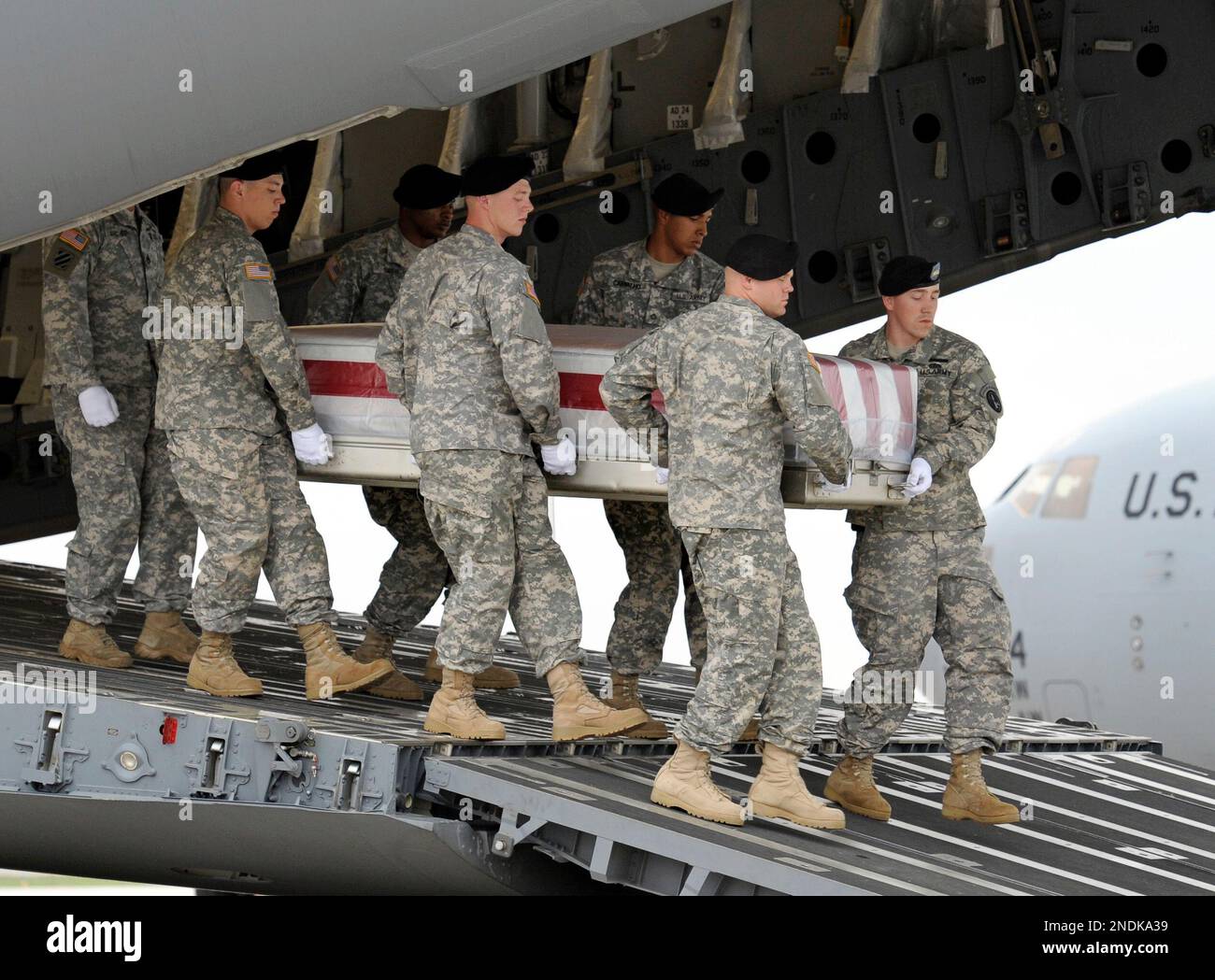 An Army carry team carries a transfer case with the unidentified ...