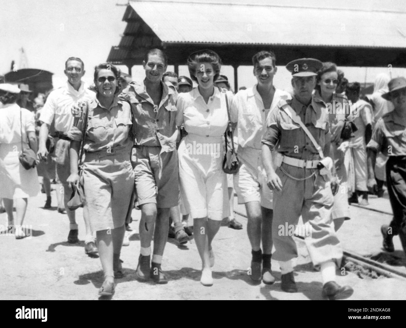 Former prisoners of war held by the Japs in Singapore, stroll arm in ...