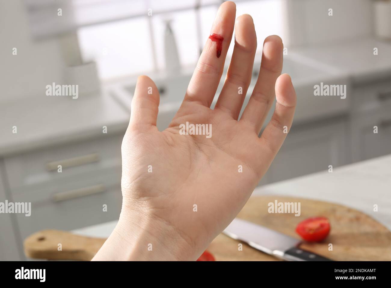 Woman cut finger while cooking in kitchen, closeup Stock Photo - Alamy