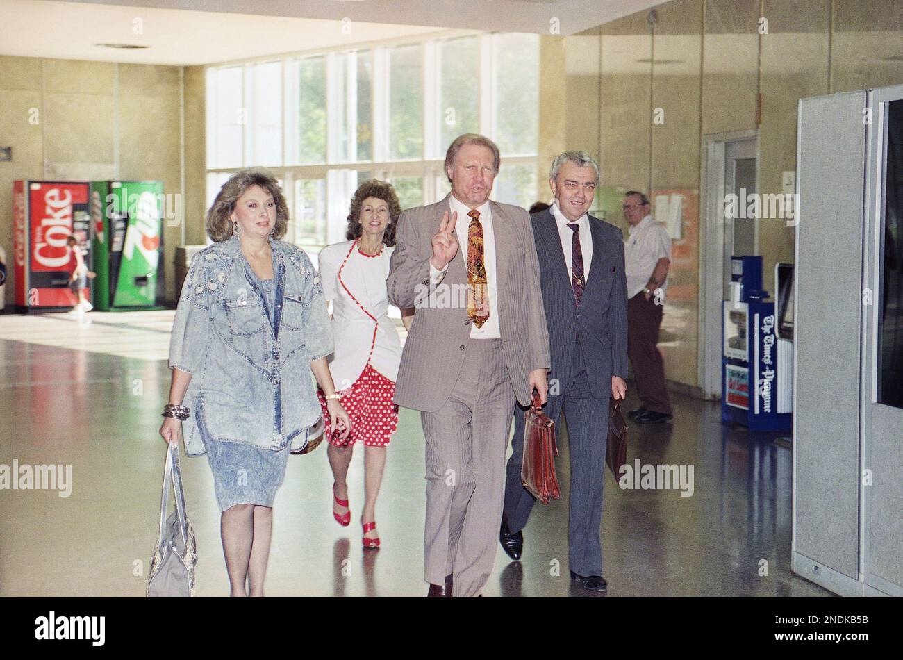 Evangelist Jimmy Swaggart counts the news media present as he enters ...