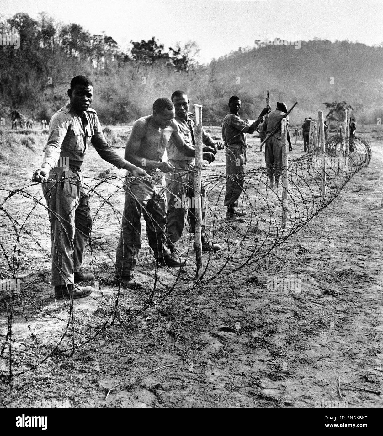West African troops string barbed wire for the defense of a strong ...