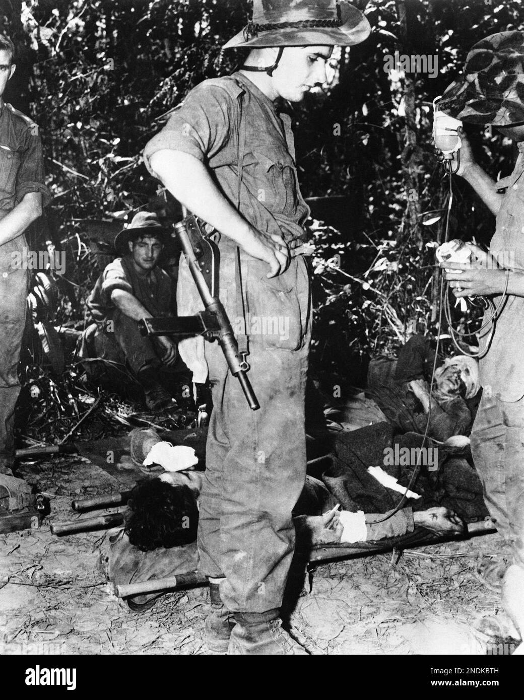 A wounded British soldier of the First Air Commando Force is given ...