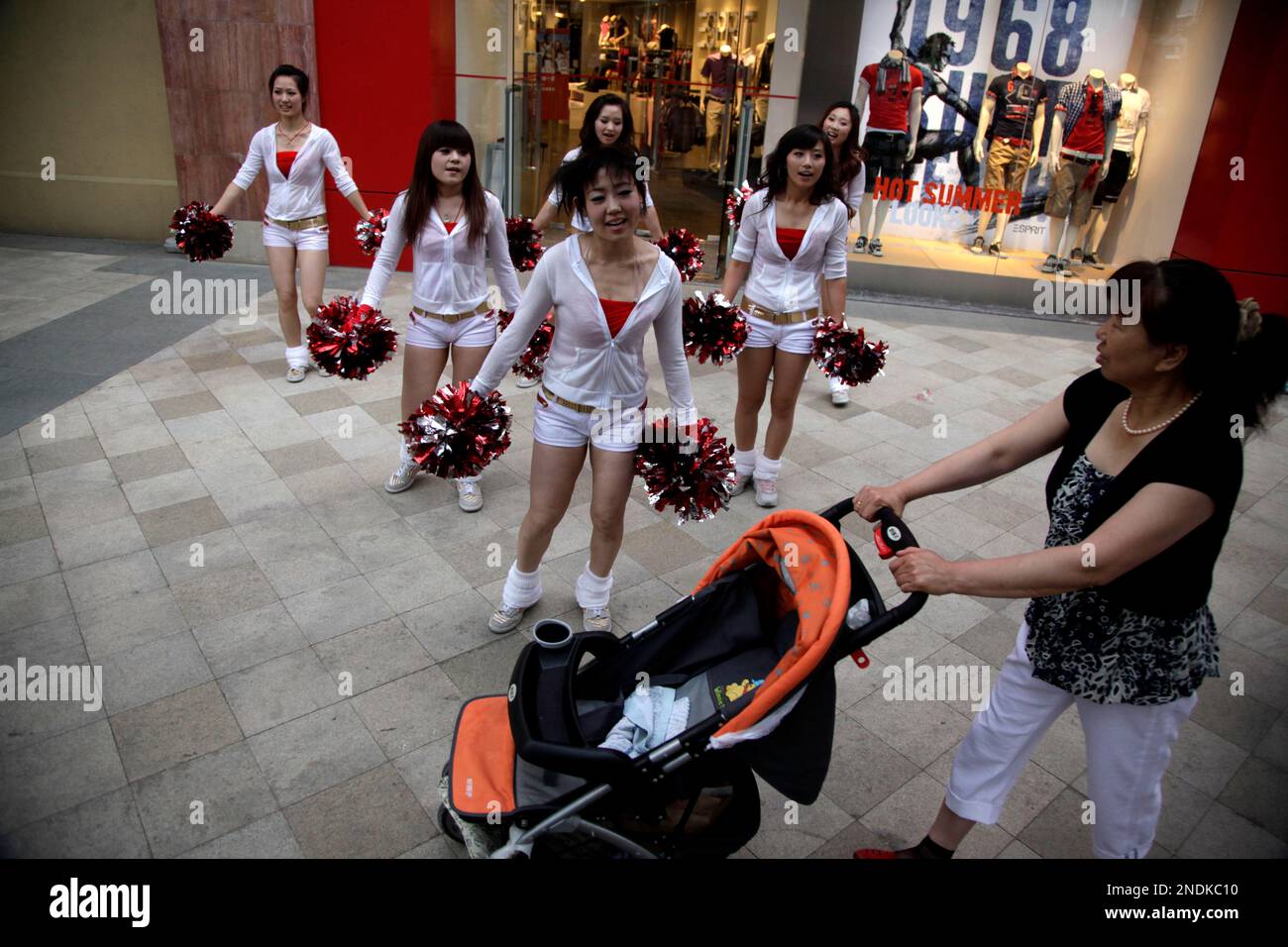 Chinese cheerleaders practice before performing at a beer garden in ...