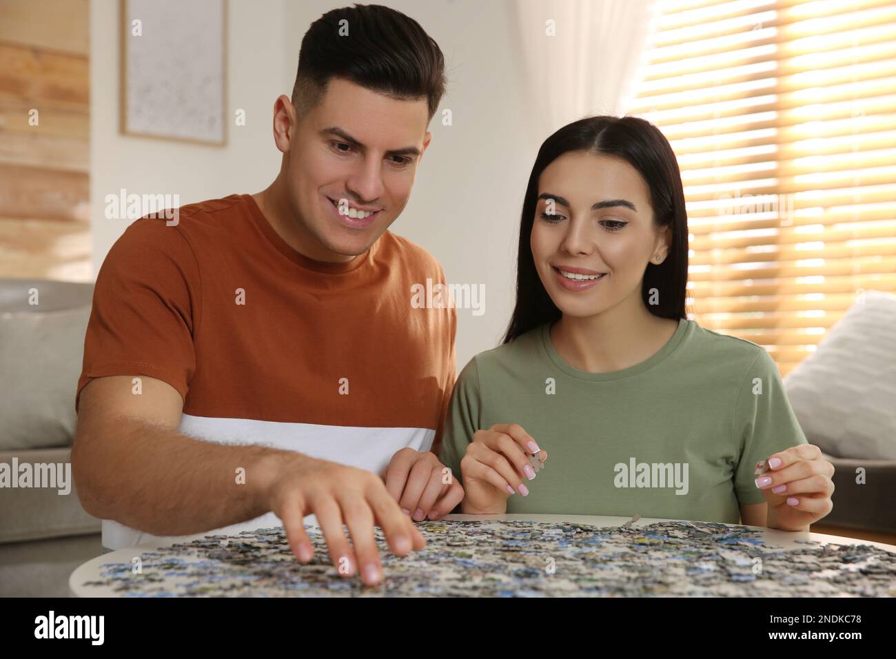 Happy woman playing puzzles hi-res stock photography and images - Alamy