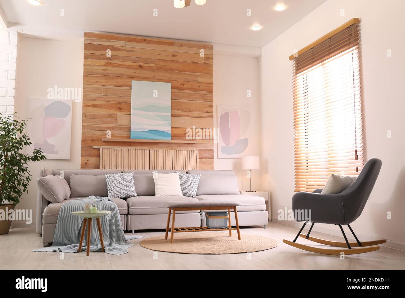 Stylish living room interior with comfortable sofa and pictures Stock ...