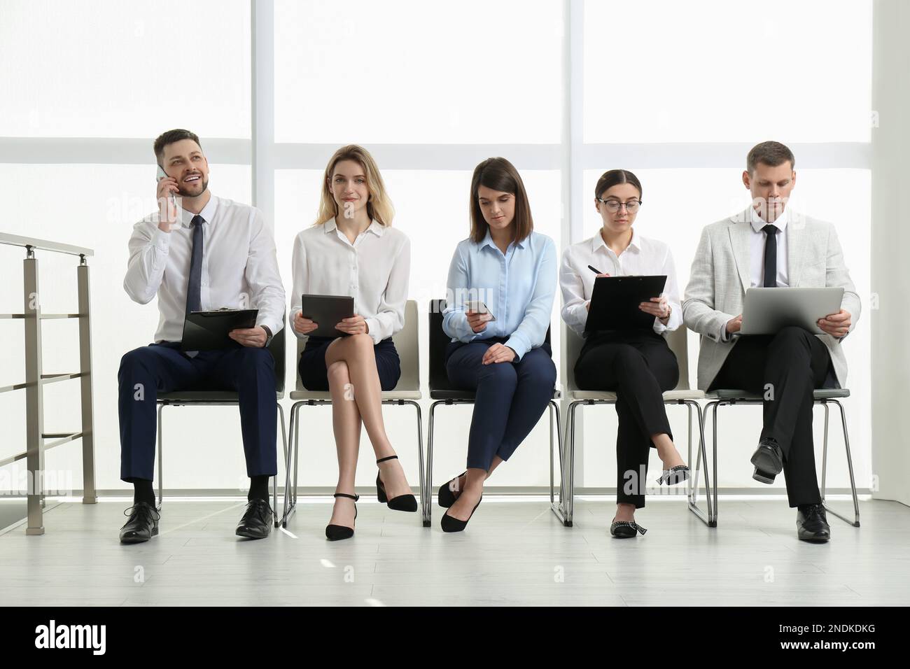 People waiting for job interview in office hall Stock Photo - Alamy