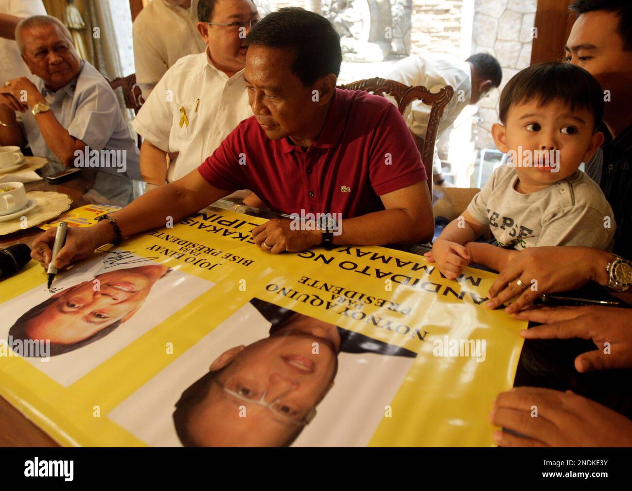 Philippine Vice President-elect Jejomar Binay, center, autographs a ...