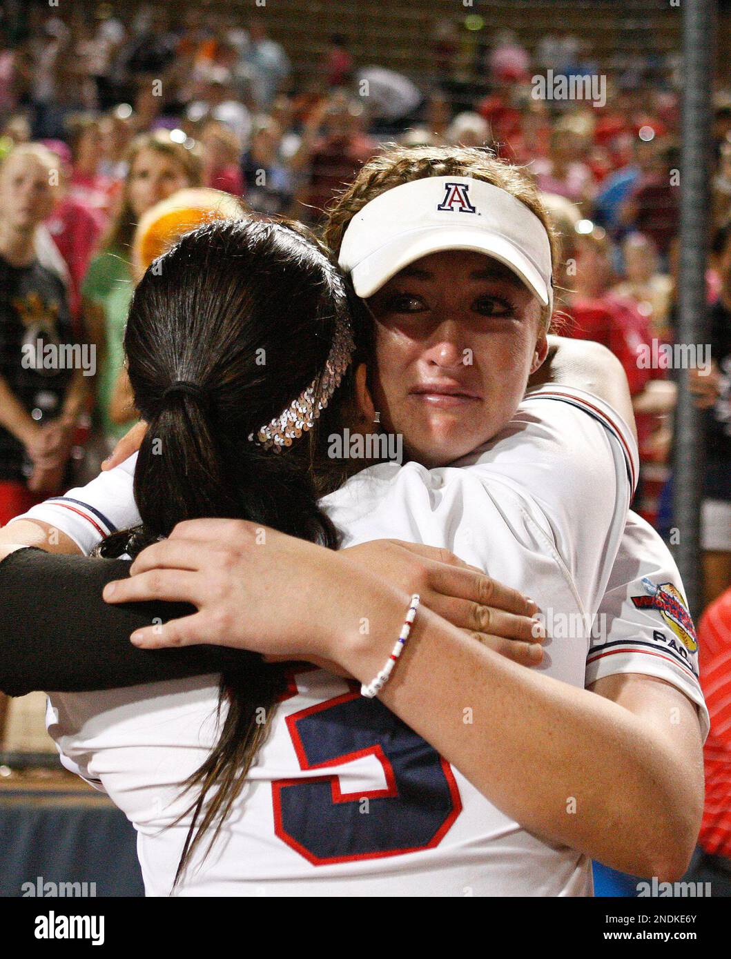 Arizona's Kenzie Fowler, back, and Sarah Akamine, front, hug each other ...