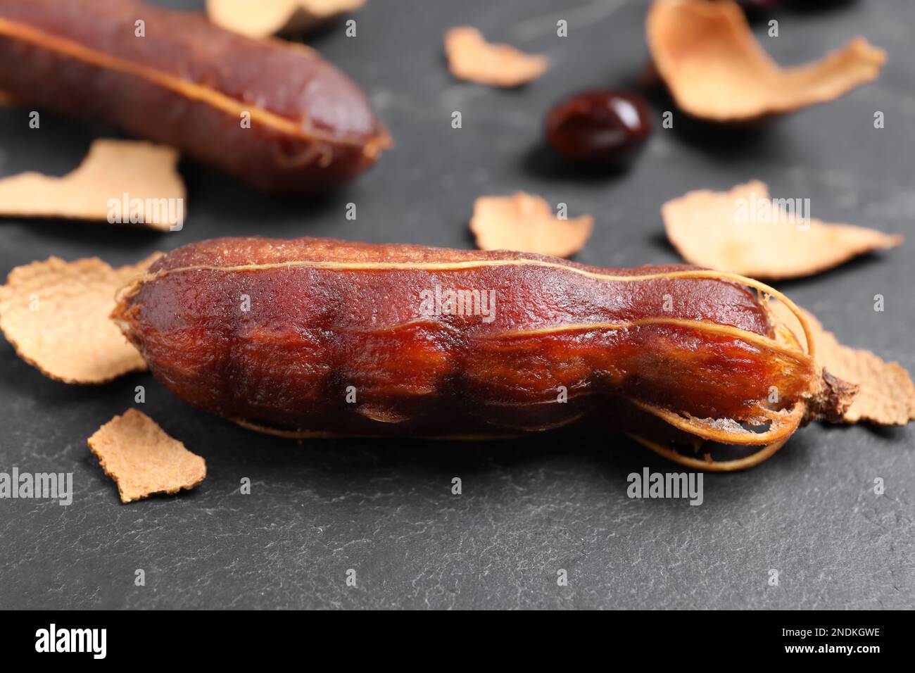 Peeled tamarind pod on black table, closeup Stock Photo - Alamy