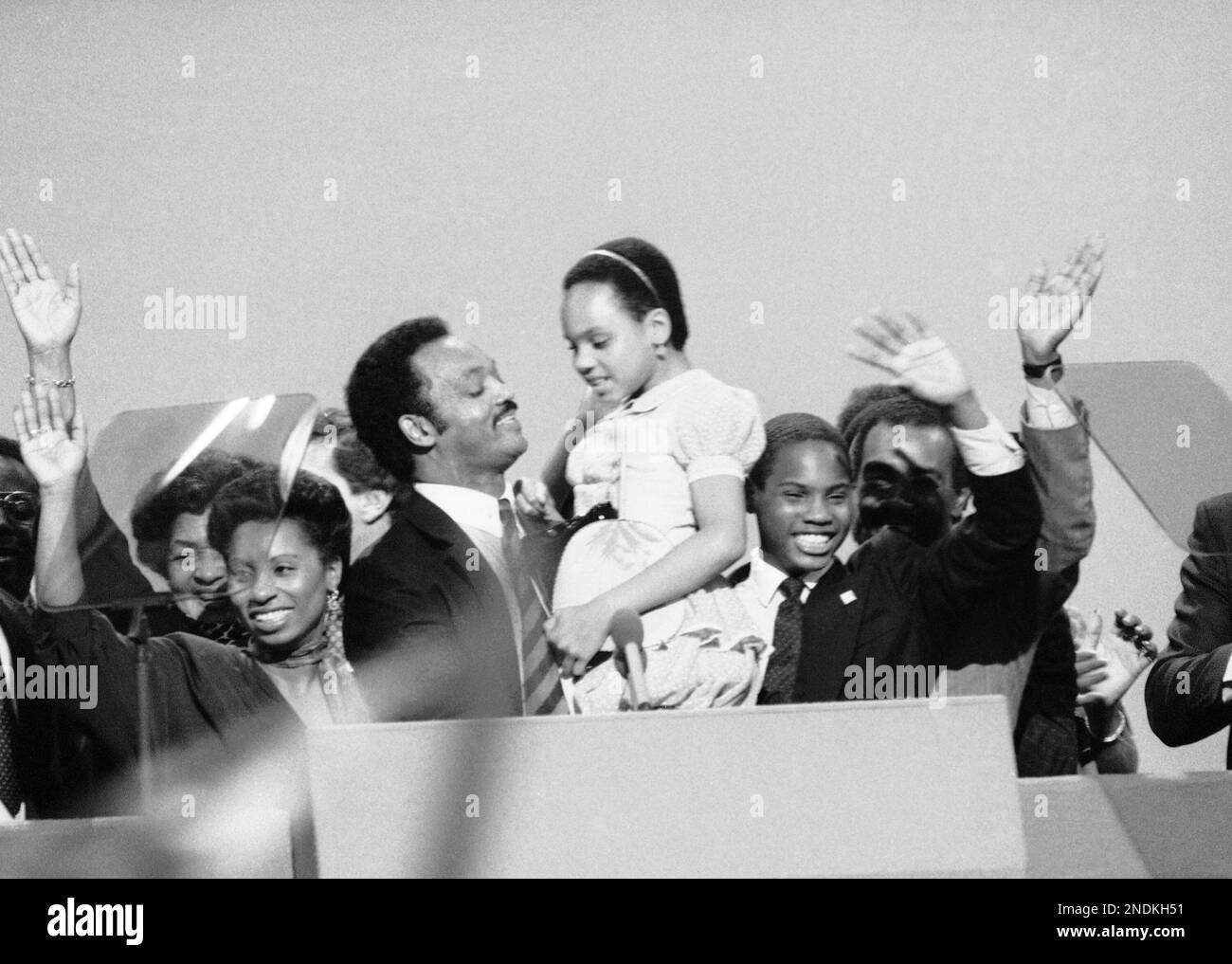 The Rev. Jesse Jackson holds his daughter Santita aloft as she gives ...