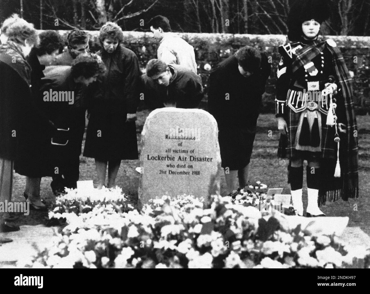 Piper Fiona McCall stands by the Memorial Stone erected to victims of ...