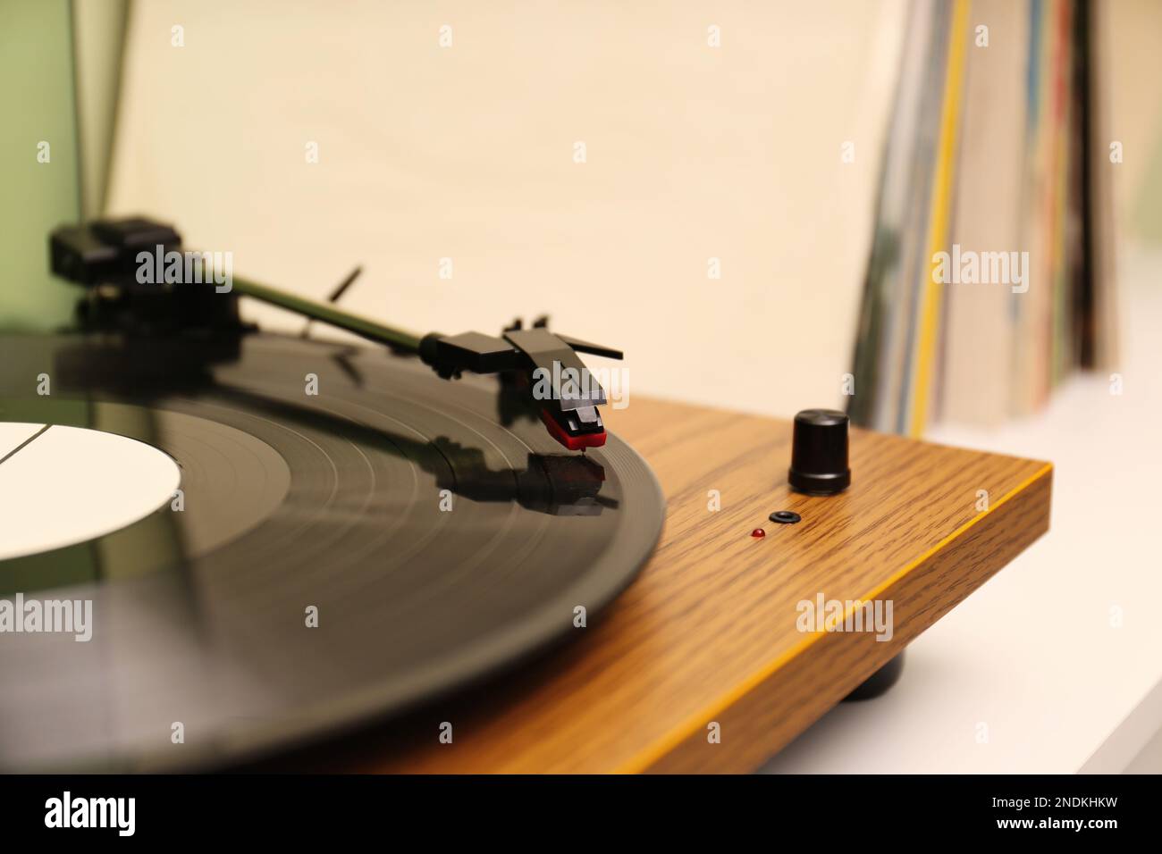 Turntable with vinyl record on white table, closeup. Space for text ...