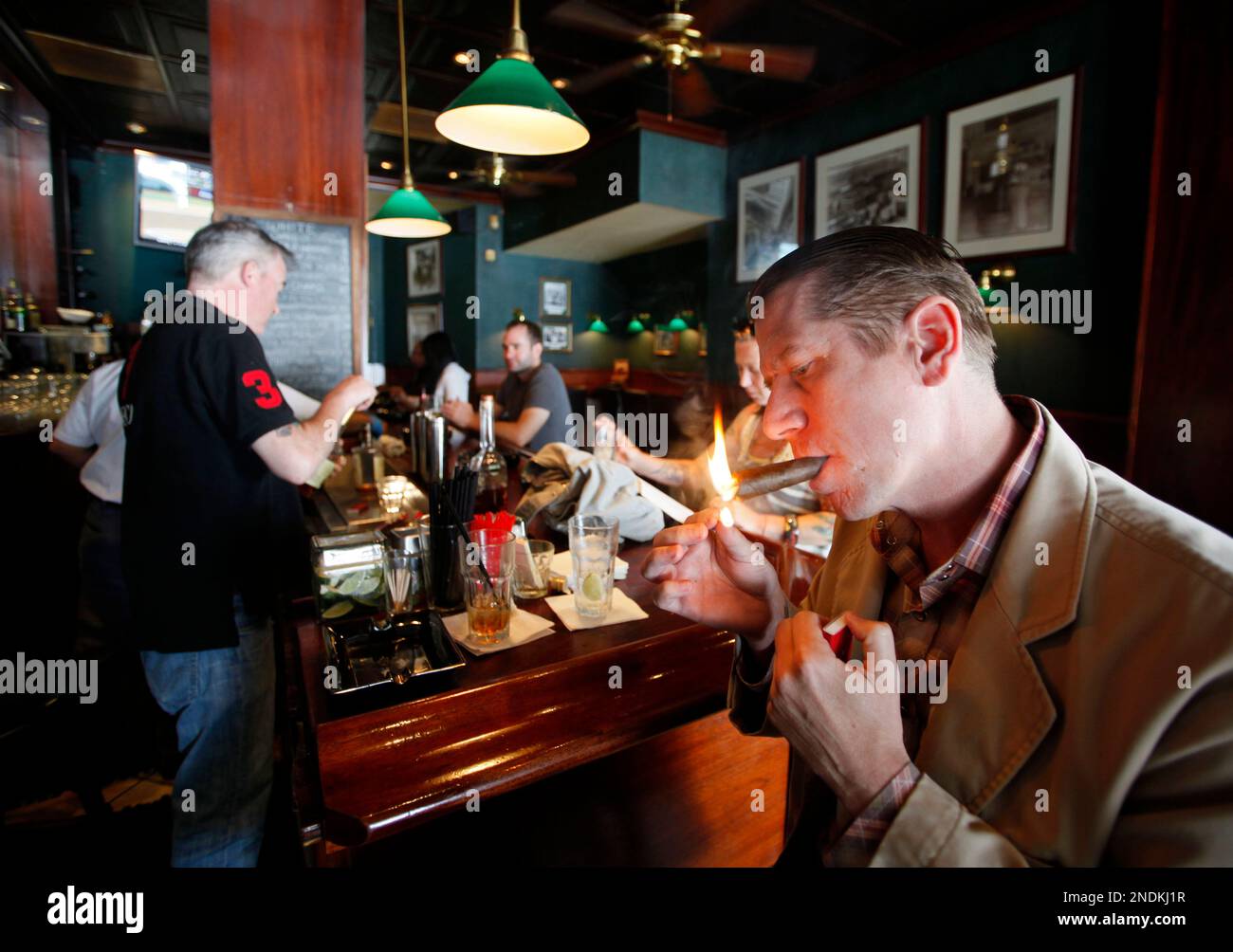 Michael Mattis of San Francisco lights up his Ashton cigar at the ...