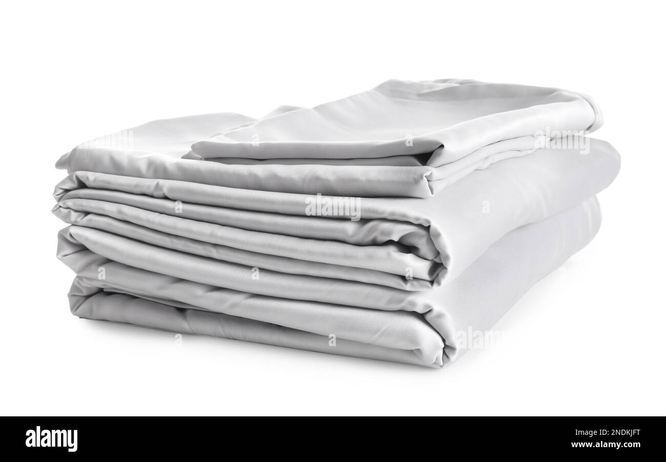 Stack of clean silky bed linen isolated on white Stock Photo - Alamy