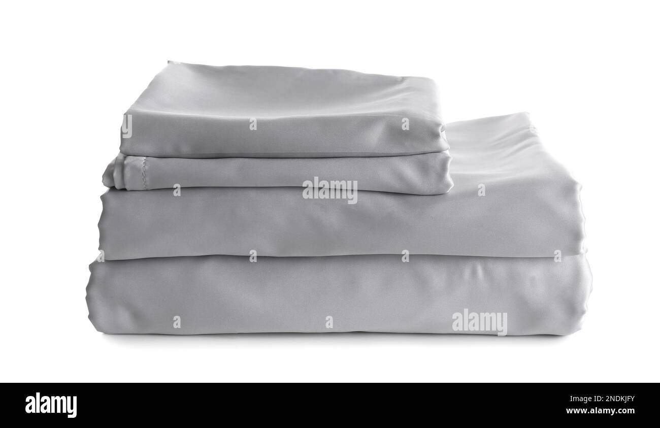 Stack of clean silky bed linen isolated on white Stock Photo - Alamy