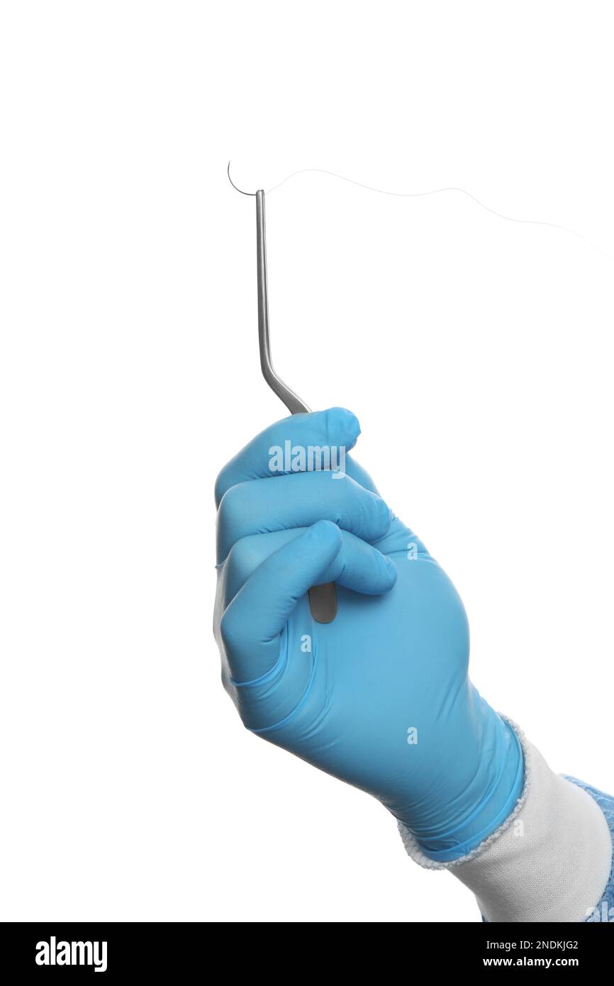 Doctor holding needle with suture thread on white background, closeup ...